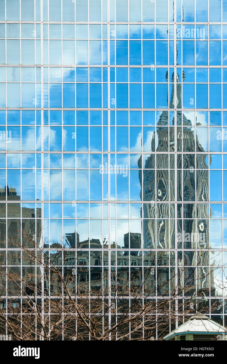 The Empire State Building reflected in a glass fronted skyscraper Stock ...