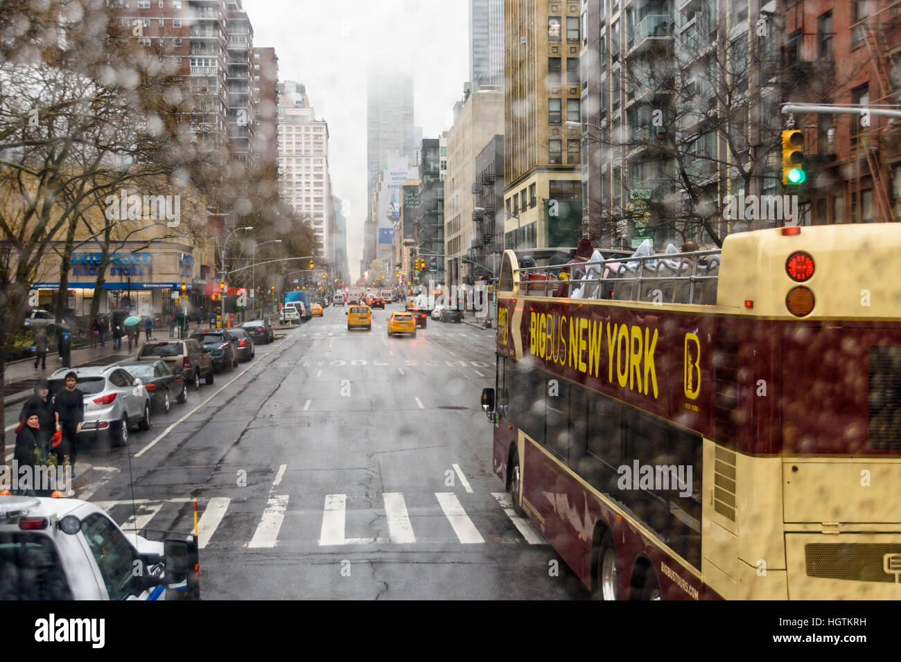 Big Bus open top bus in New York seen through a raindrop covered window ...