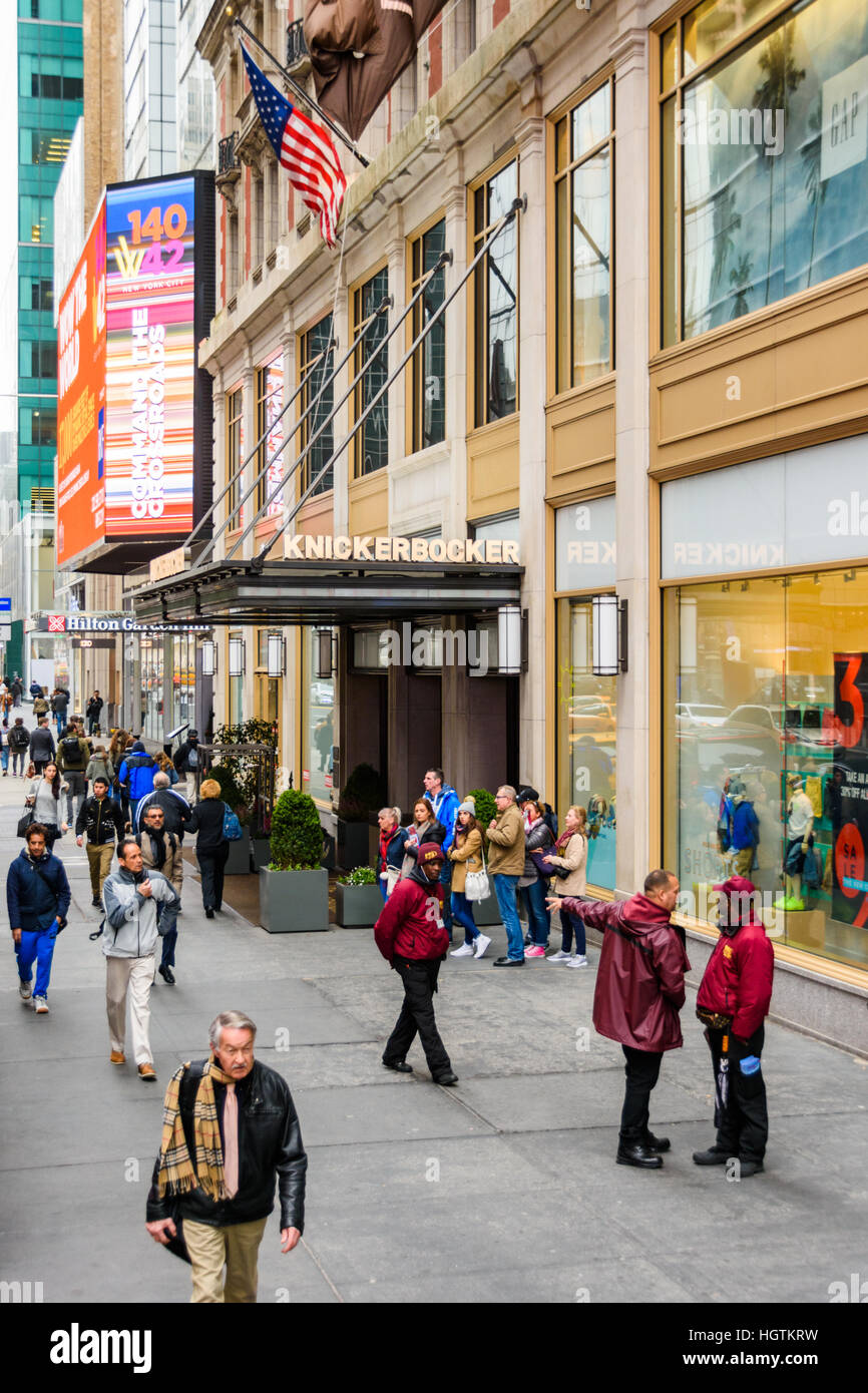 People walking along the sidewalk outside the Knickerbocker Hotel in ...