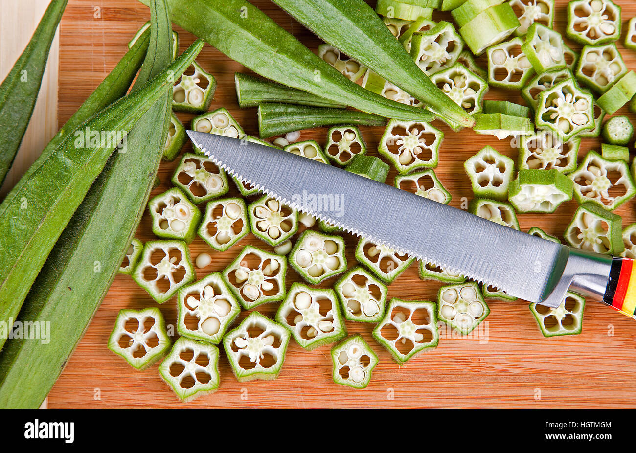 chopped lady finger on a chopping board Stock Photo - Alamy