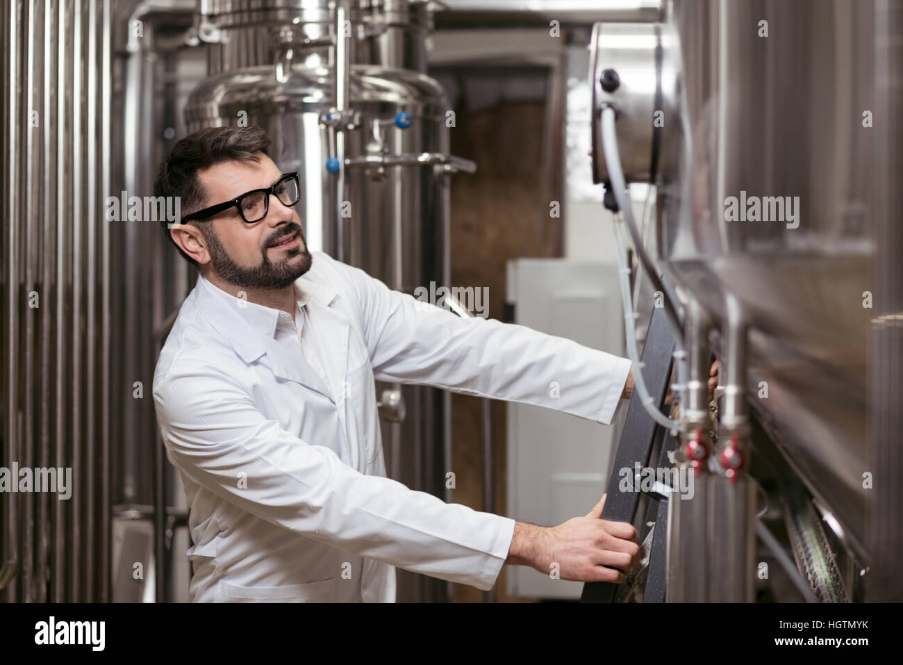 Handsome man working on factory Stock Photo - Alamy