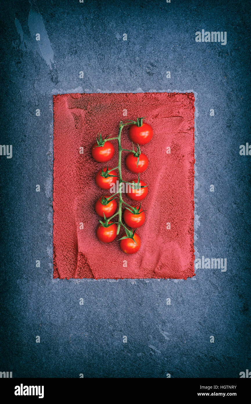Vine tomatoes on tomato paste and slate. Retro filter applied Stock ...
