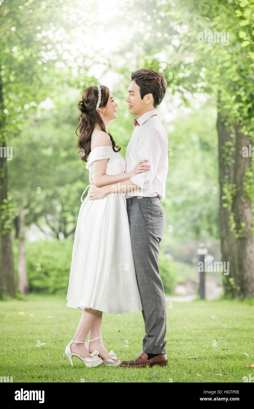 Side view of young romantic couple hugging face to face outdoors Stock ...