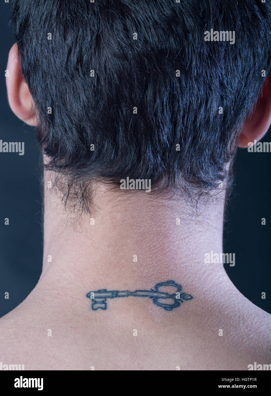 portrait of young man back with a key tattoo Stock Photo - Alamy