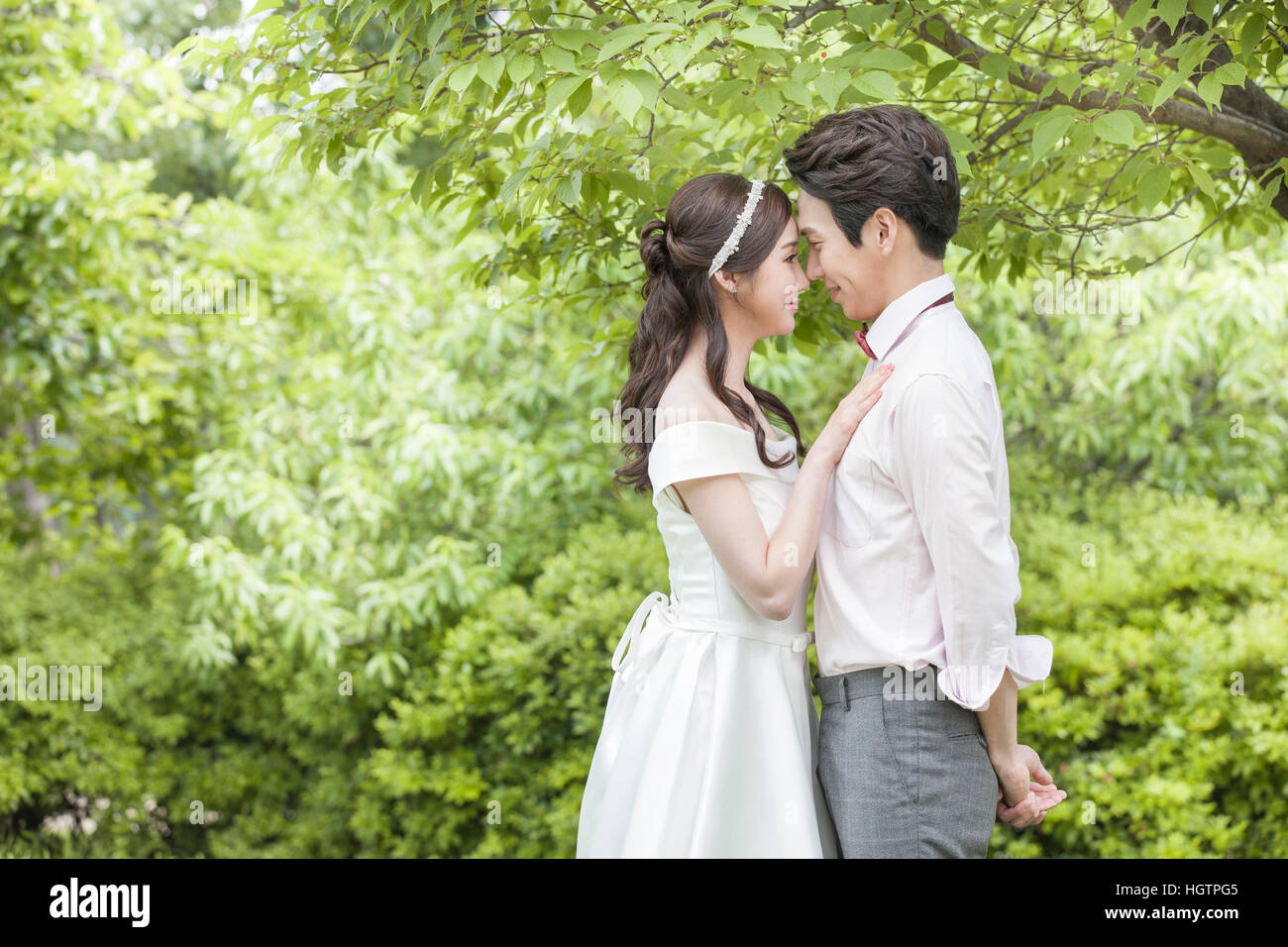 Side view of young romantic couple face to face outdoors Stock Photo ...