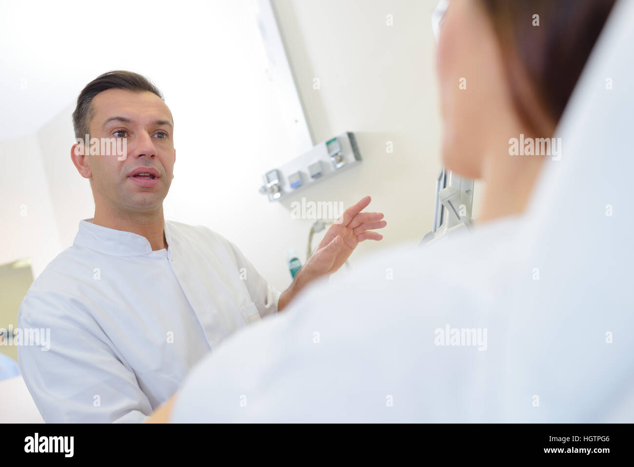 Doctor in conversation with patient Stock Photo - Alamy