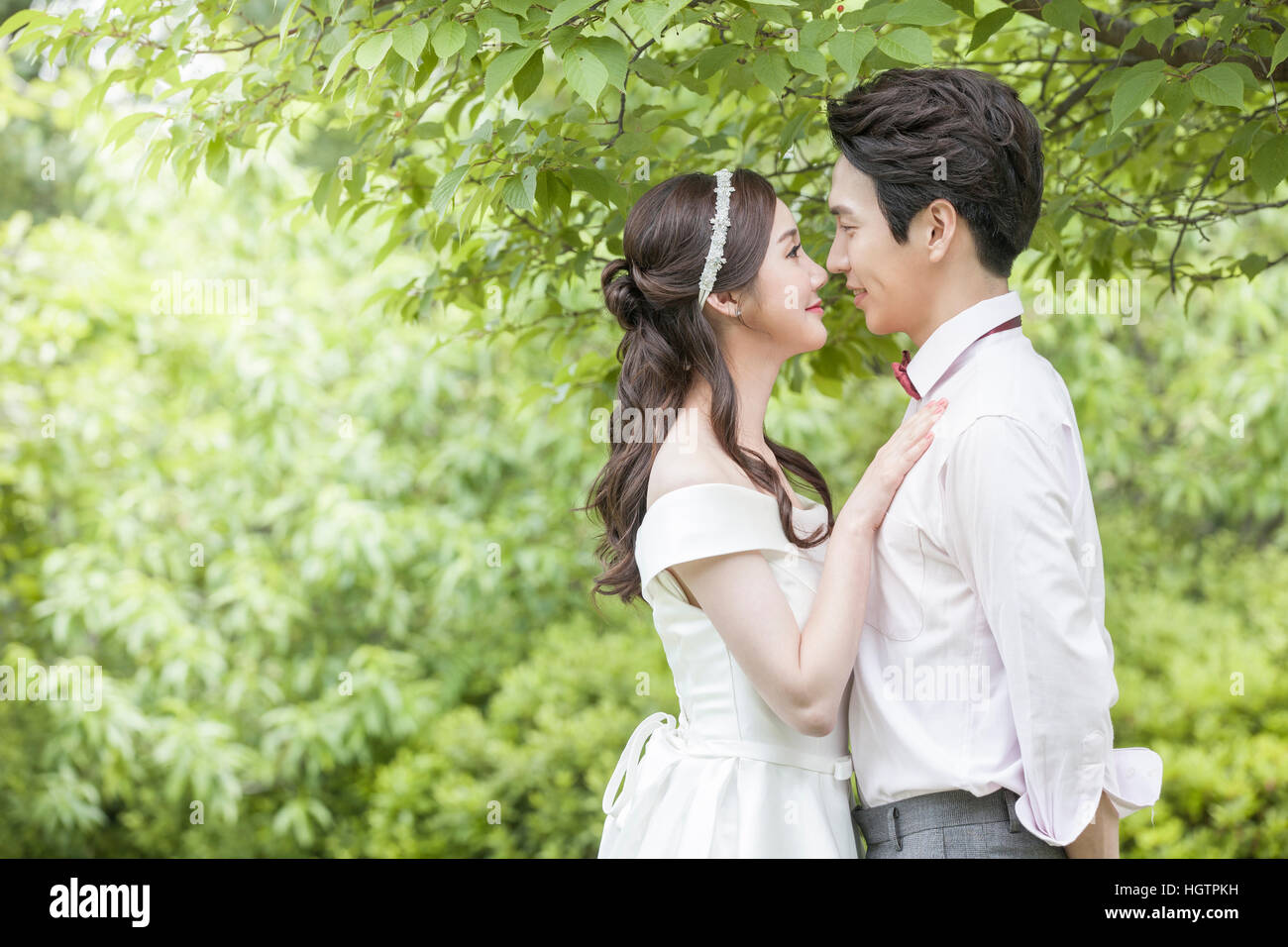 Side view portrait of young romantic couple hugging face to face ...
