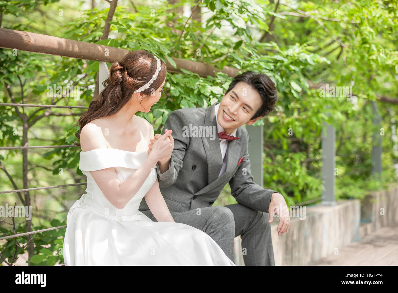 Young romantic wedding couple smiling at each other outdoors Stock ...