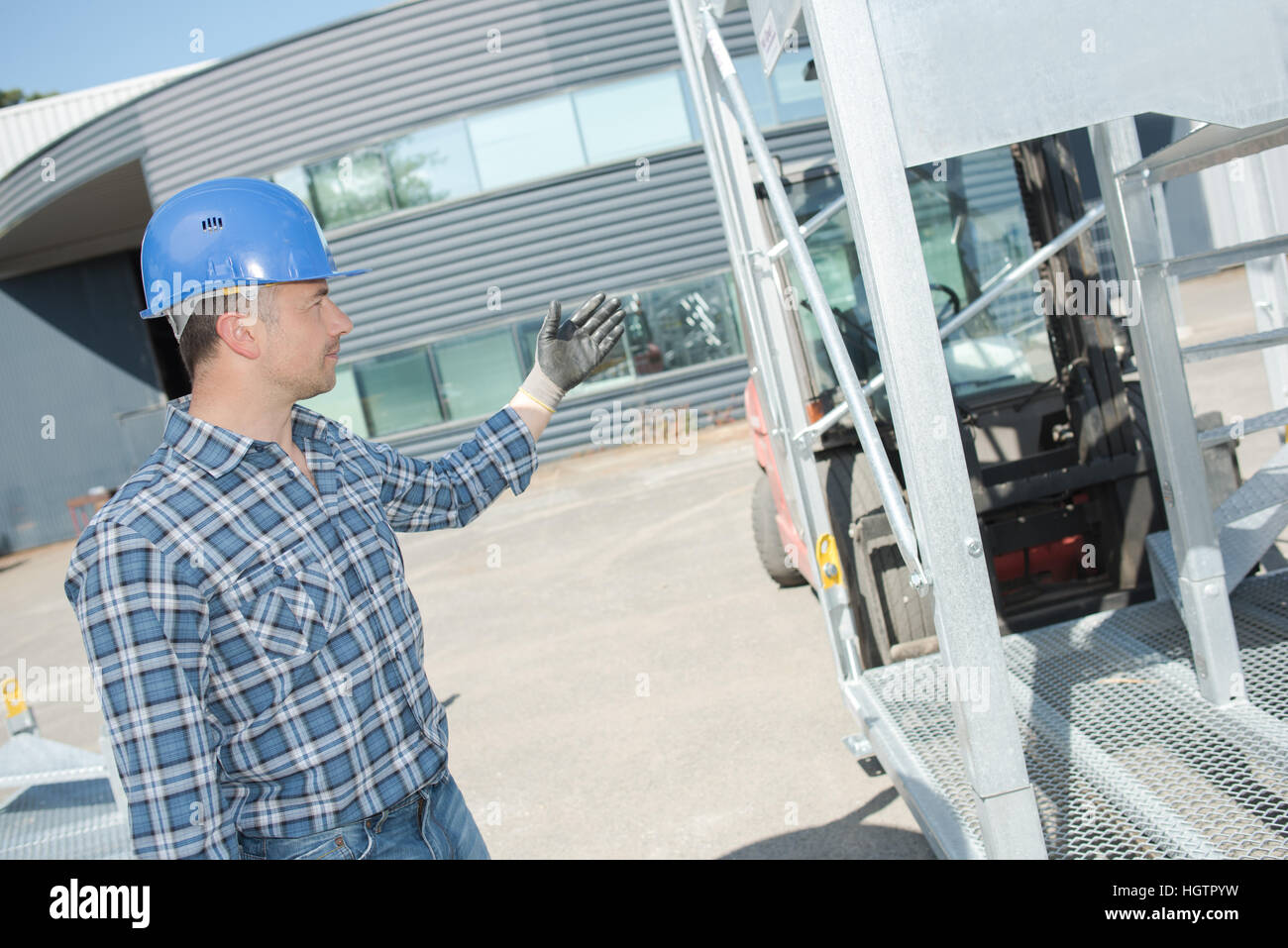 Man directing forklift Stock Photo - Alamy
