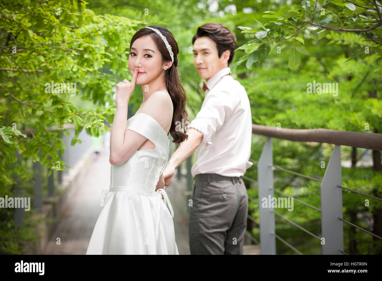 Side view of young smiling wedding couple outdoors Stock Photo - Alamy
