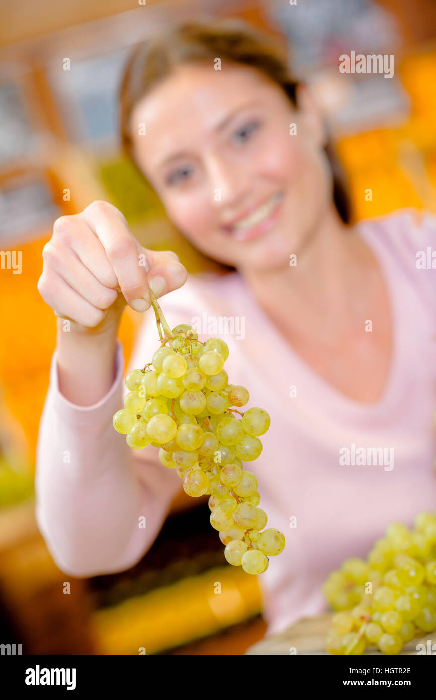 Woman holding grapes Stock Photo - Alamy