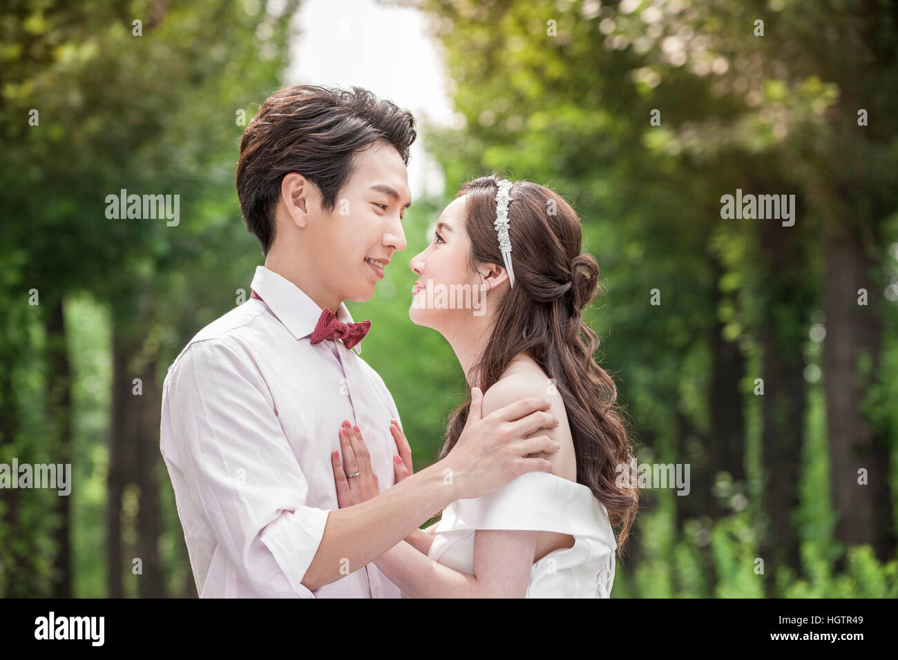 Side view portrait of young romantic couple hugging face to face ...
