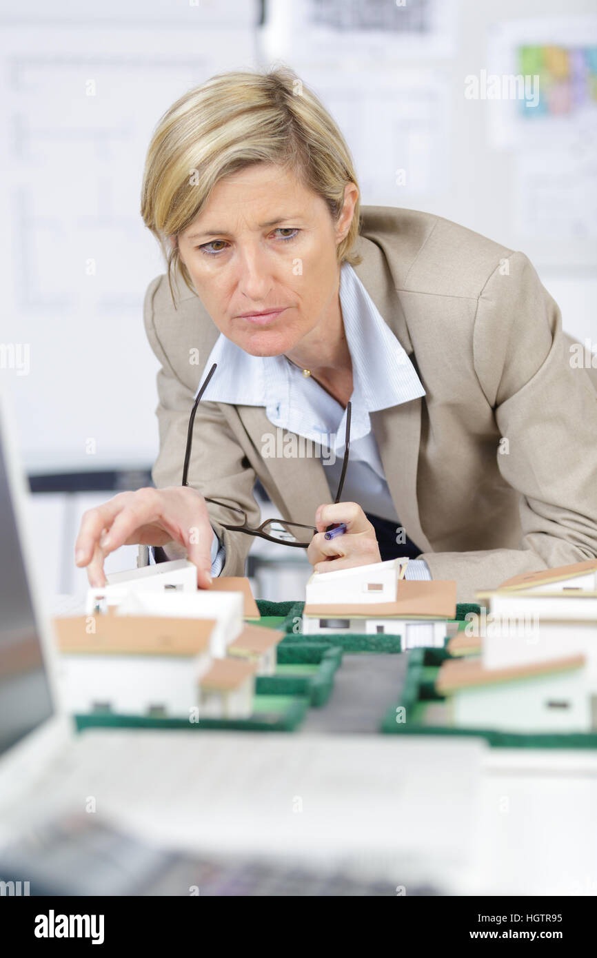 female realtor looking at a new-build property model Stock Photo - Alamy