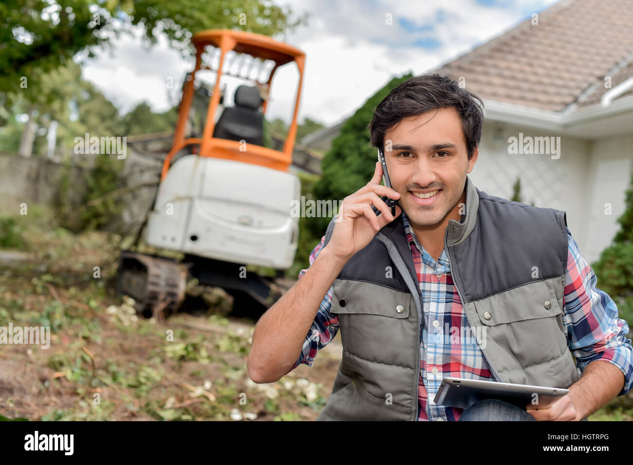 Cheerful foreman taking a call Stock Photo - Alamy
