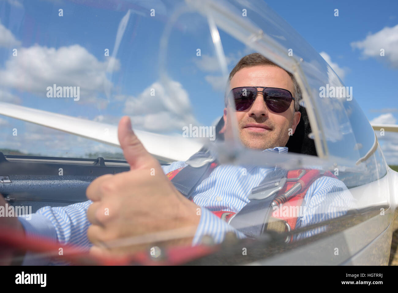 Man in glider holding up thumb Stock Photo - Alamy Man in glider holding up thumb Stock Photo - Alamy