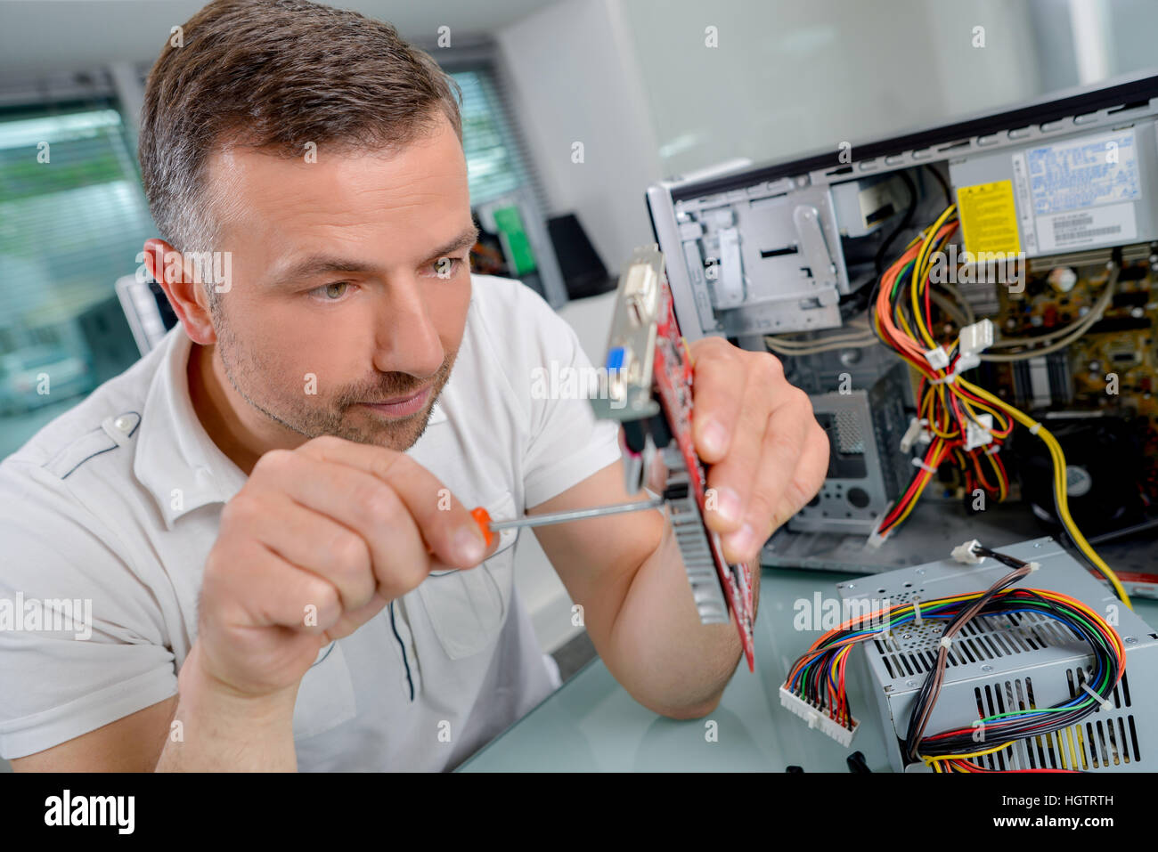 Man working on computer component Stock Photo - Alamy