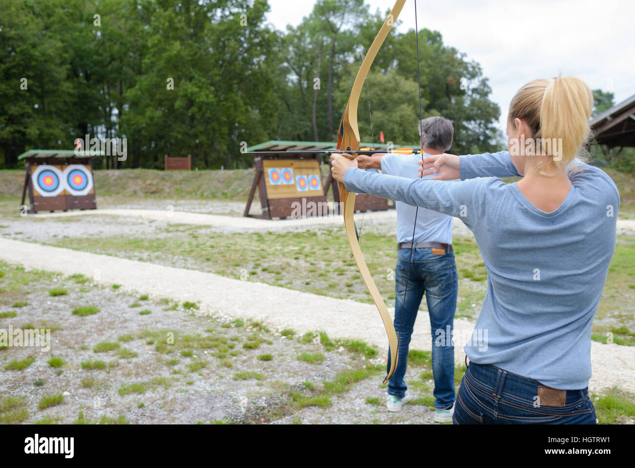 Man and woman in archery training Stock Photo - Alamy