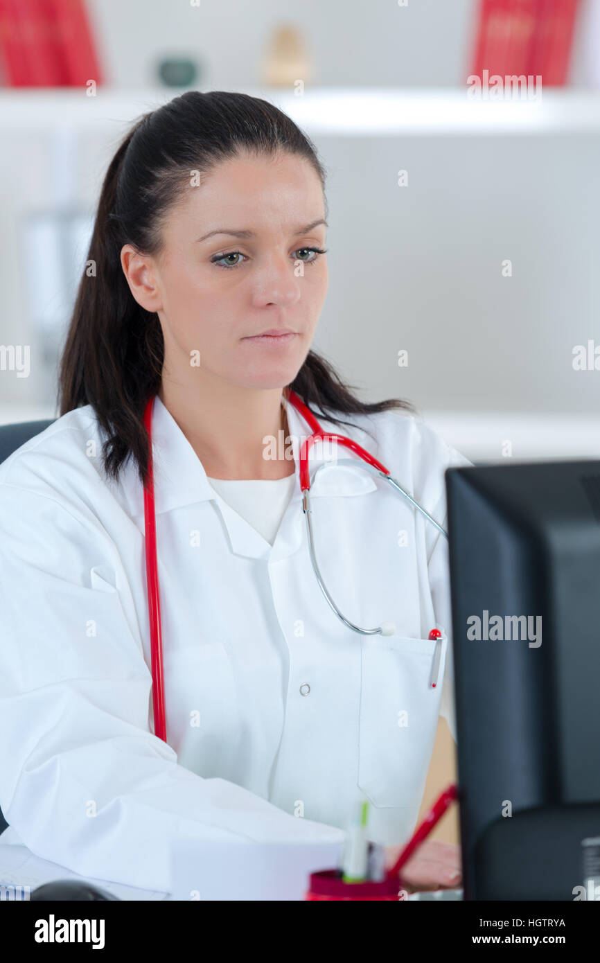 doctor with laptop writing in doctors offic Stock Photo - Alamy