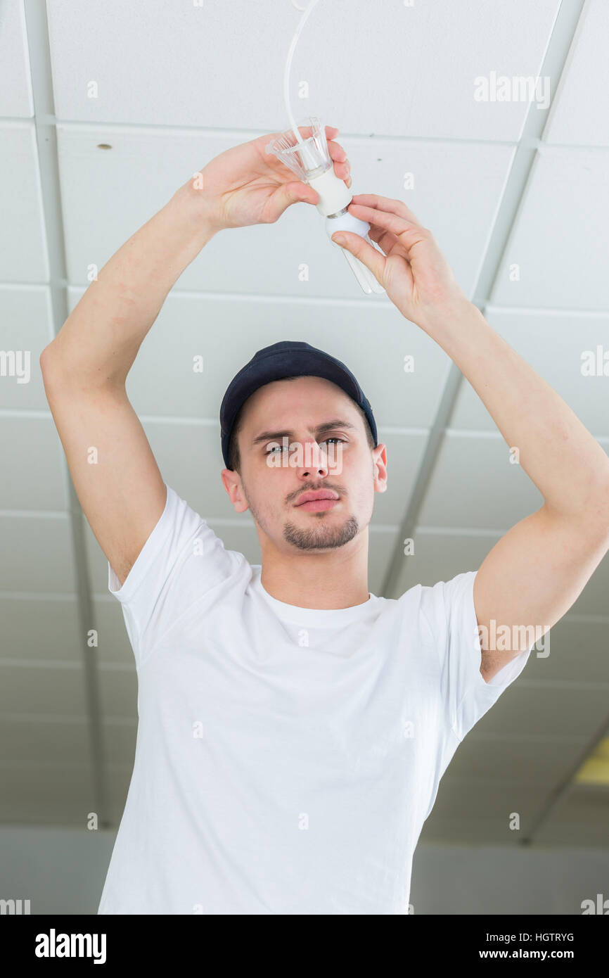 Man fitting bulb Stock Photo - Alamy