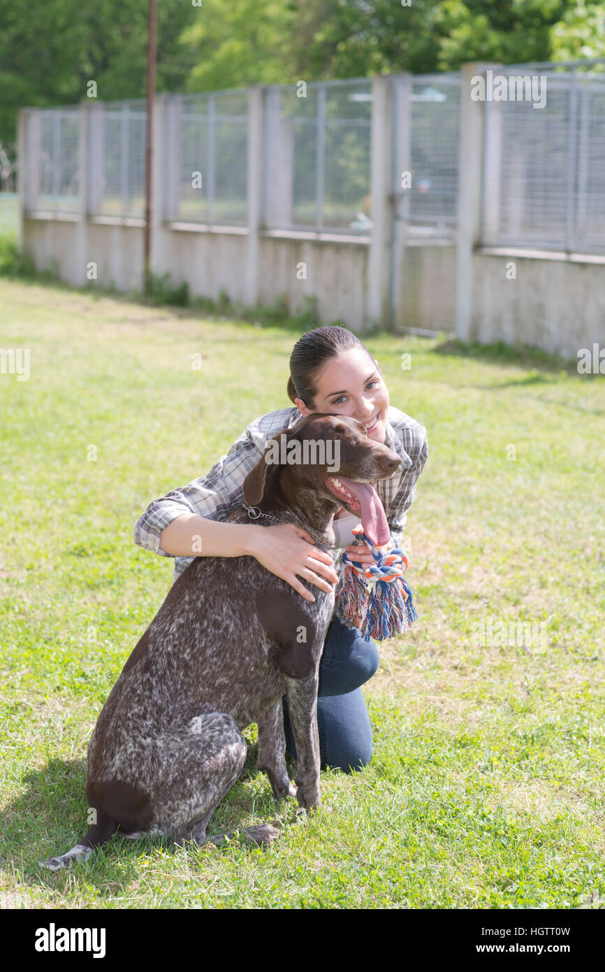 dedicated girl training dog in kennel Stock Photo - Alamy