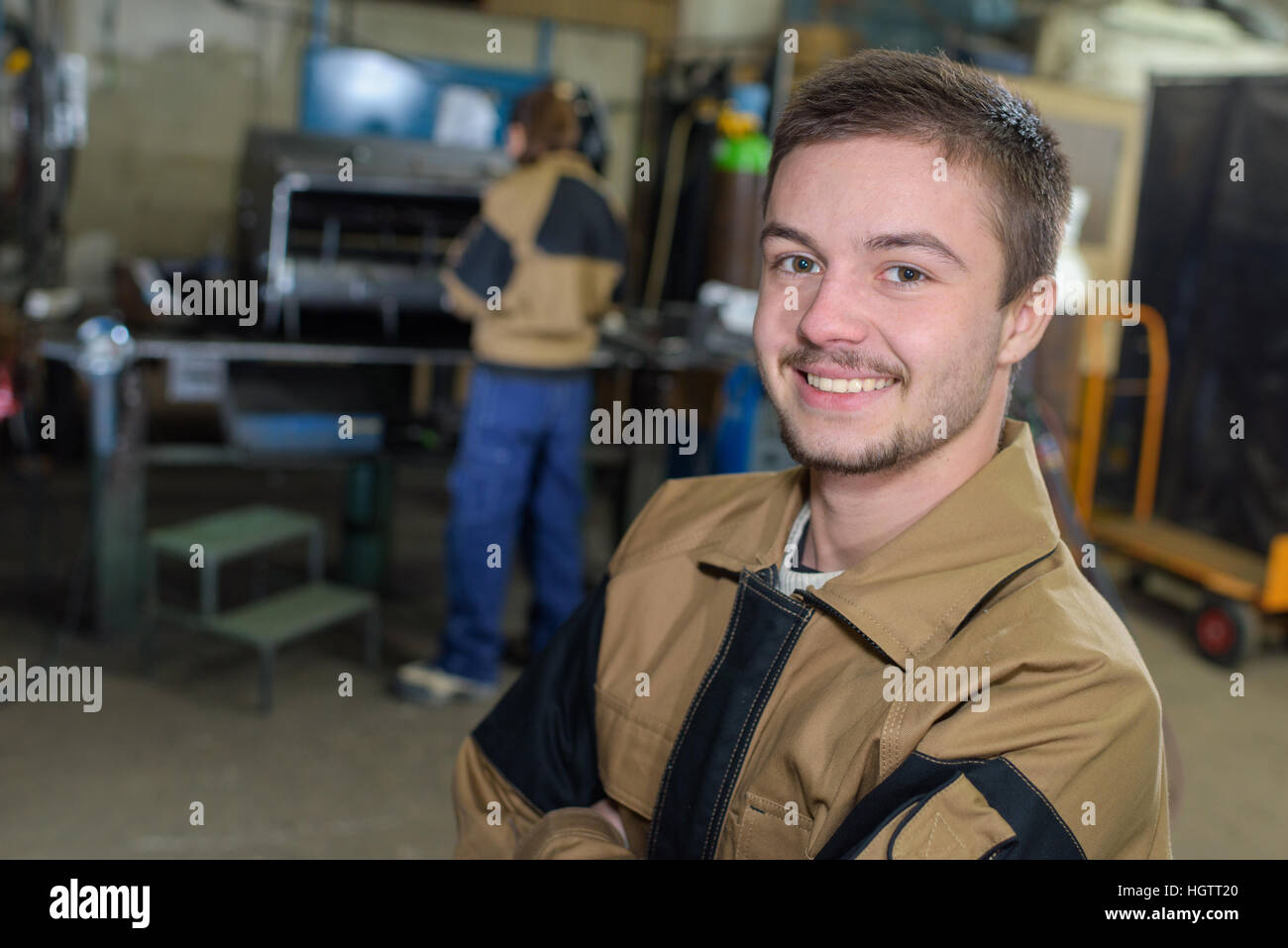 factory worker posing and smiling Stock Photo - Alamy