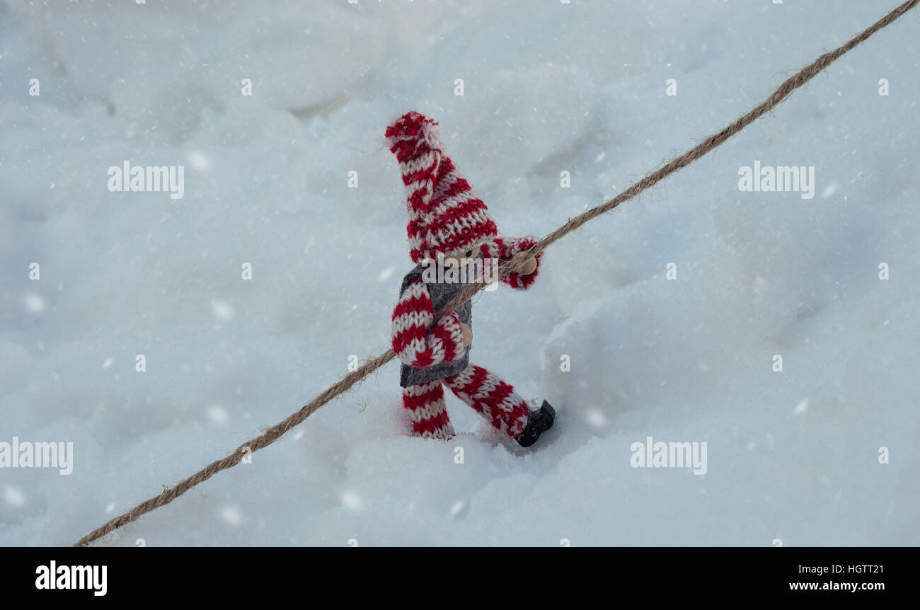 toy little man holding on to a rope, rescue scene in the winter Stock ...