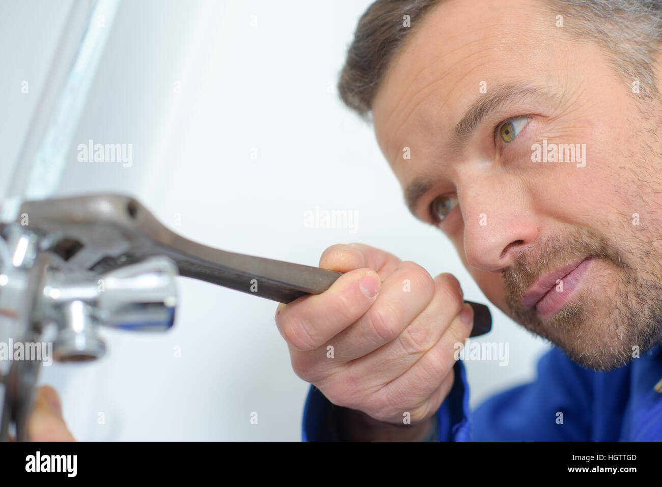 Plumber hard at work on a job Stock Photo - Alamy