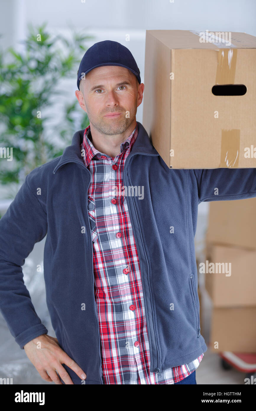 post delivery concept - smiling man carrying carton box Stock Photo - Alamy