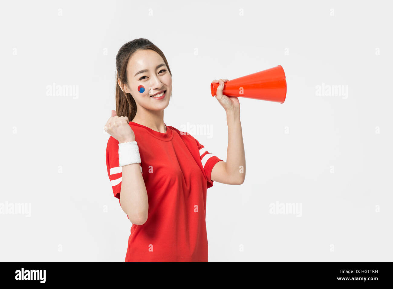 Portrait of young smiling cheerleader woman holding a megaphone Stock ...