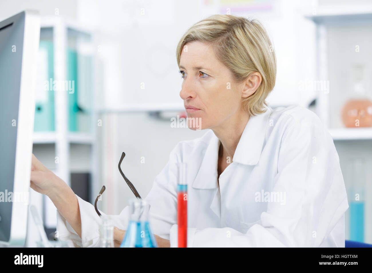 beautiful female lab worker analyzing tests Stock Photo - Alamy