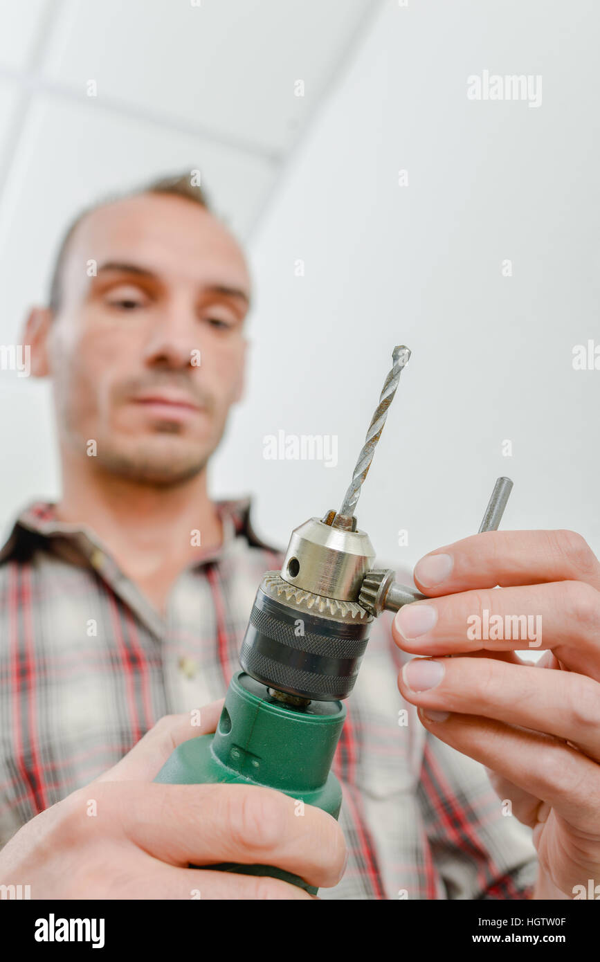 Young worker using drill hi-res stock photography and images - Alamy