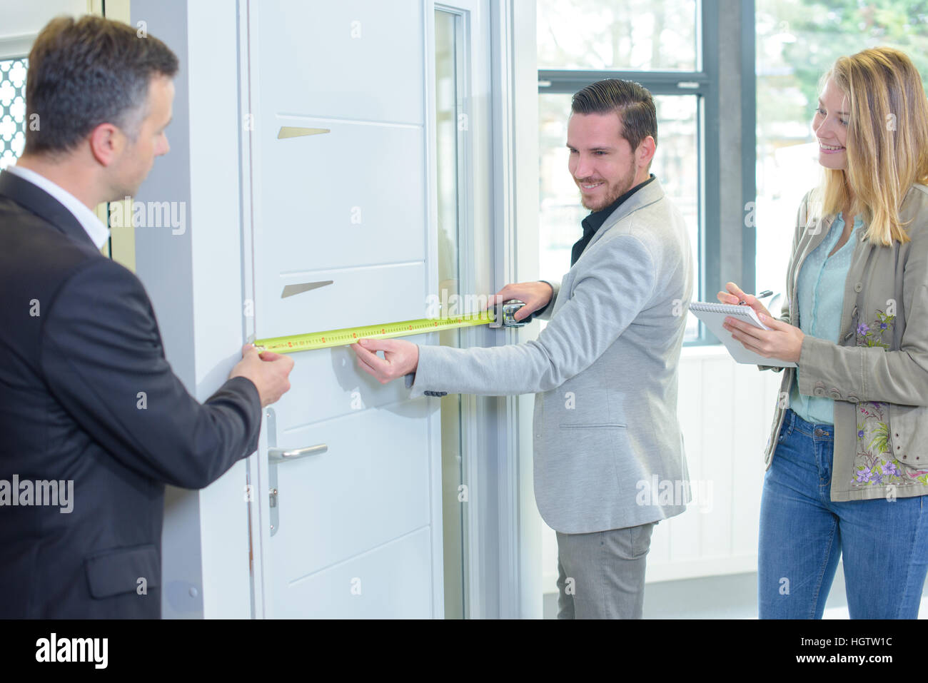 Man measuring a door Stock Photo - Alamy
