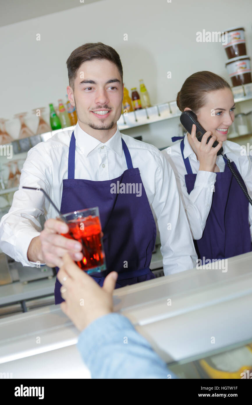 waiter serving drinks Stock Photo - Alamy