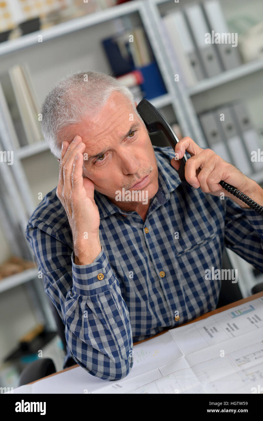 Stressed senior office worker Stock Photo - Alamy