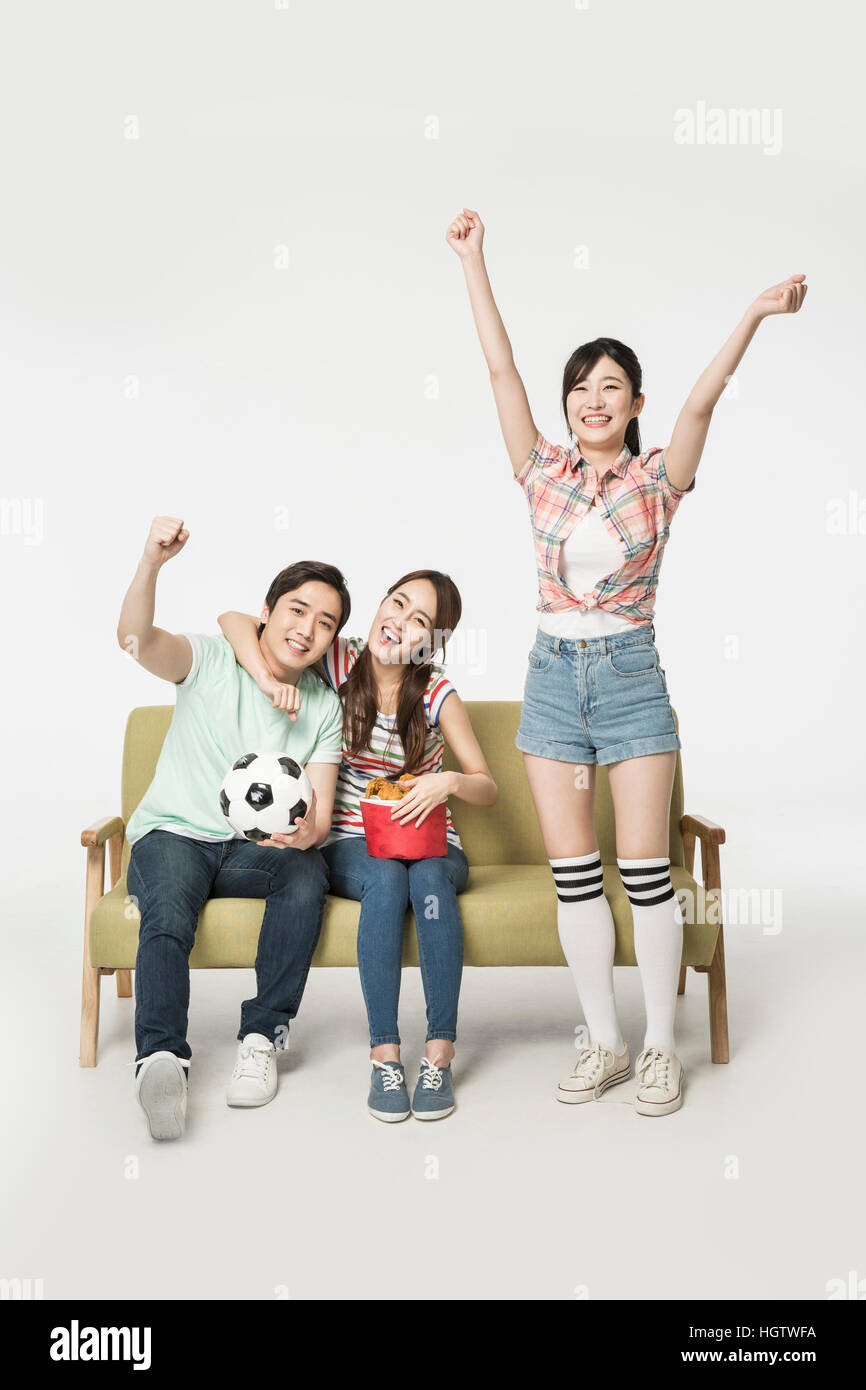 Young smiling people cheering for soccer team Stock Photo - Alamy