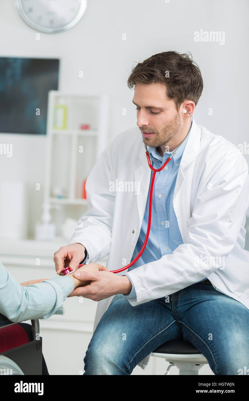 doctor ausculting with stethoscope Stock Photo - Alamy