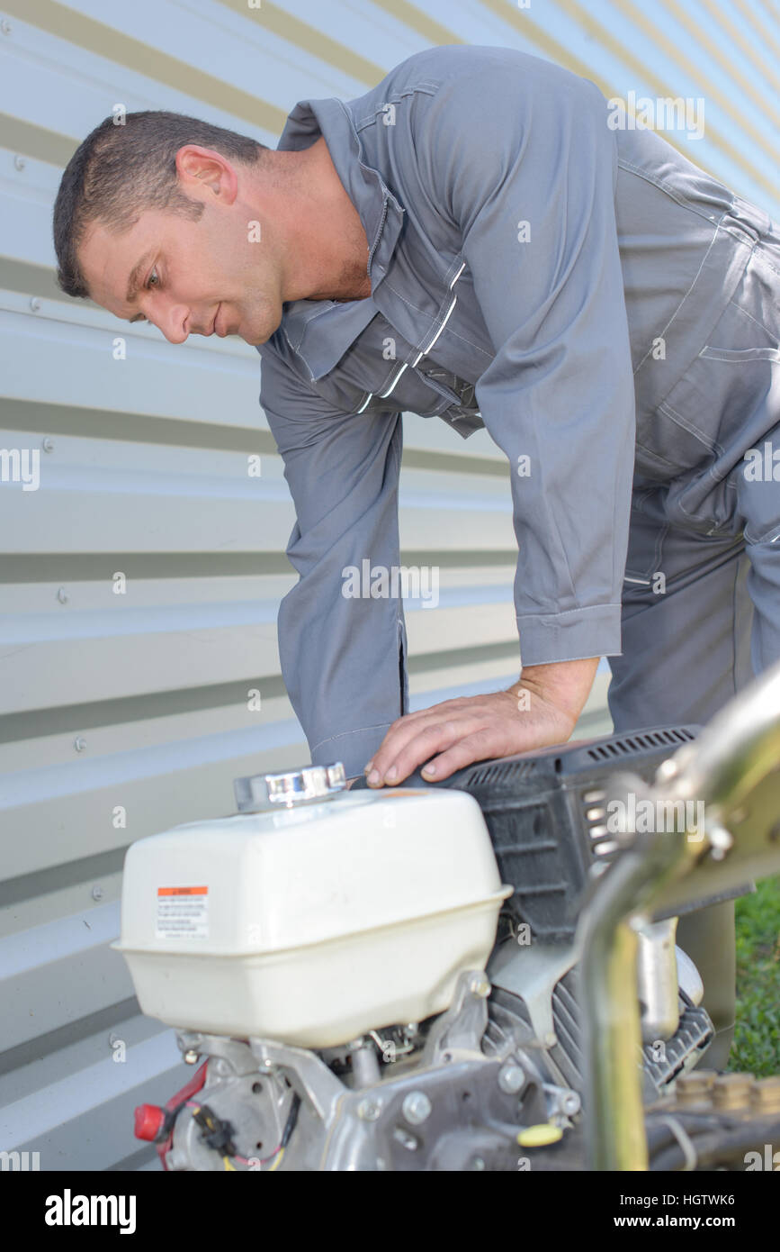 Man poised to start generator Stock Photo - Alamy
