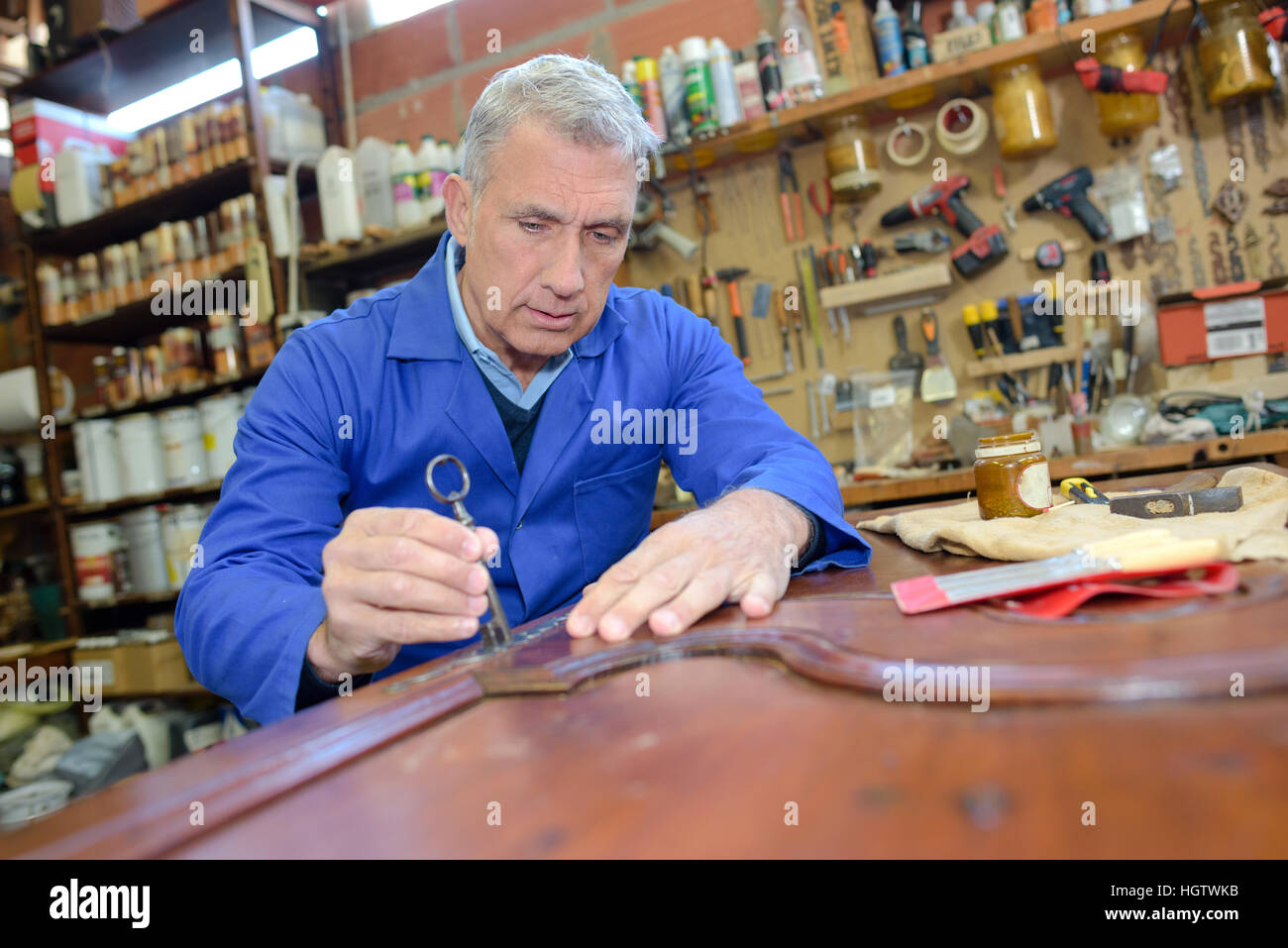 older man restoring a table Stock Photo - Alamy