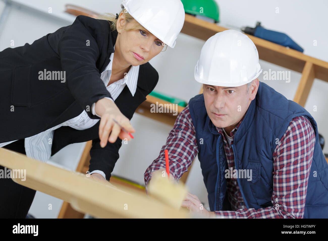 female architect and construction worker looking at scale model Stock ...