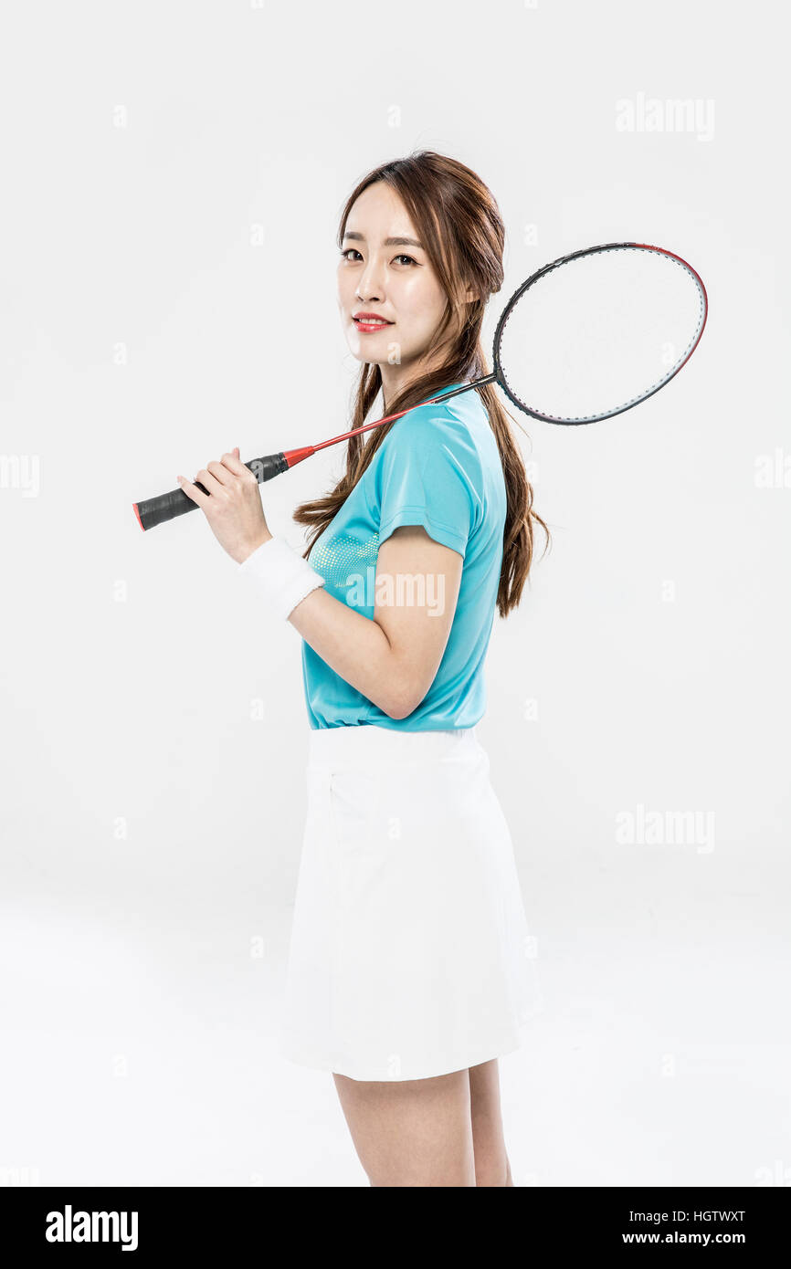 Side view of young smiling female badminton player Stock Photo - Alamy