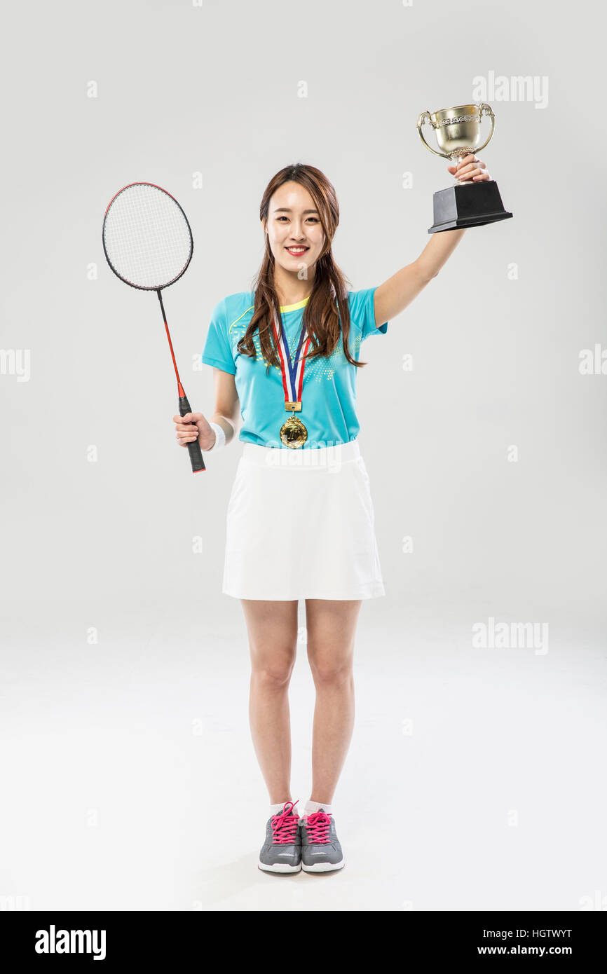 Young smiling female badminton player winning trophy Stock Photo - Alamy
