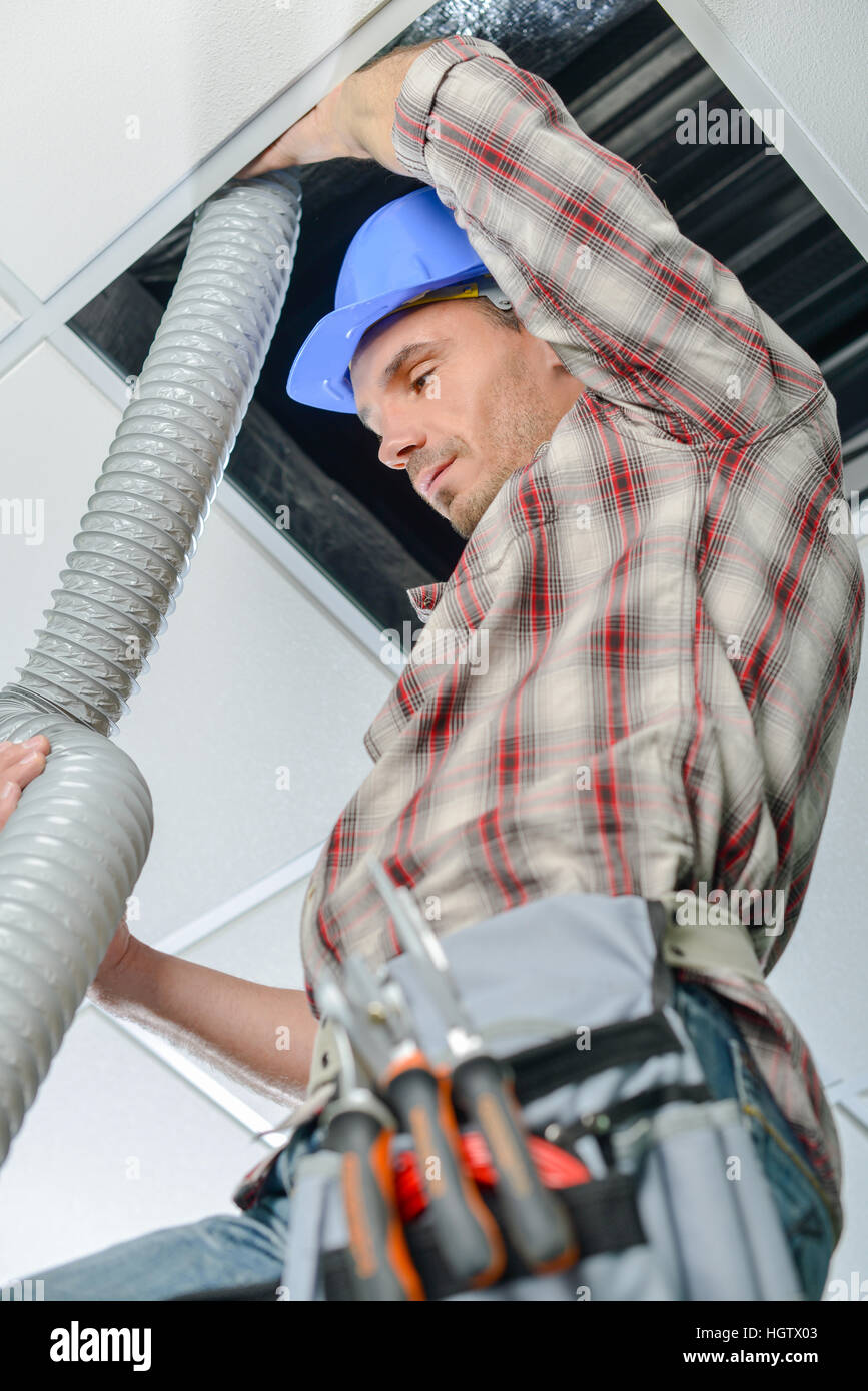 Electrician working up a ladder Stock Photo - Alamy