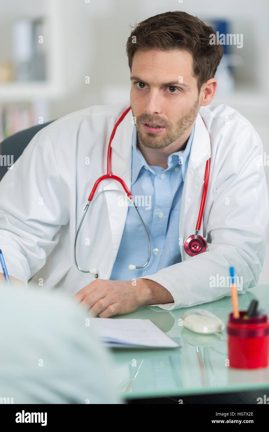 handsome young doctor at work in his office Stock Photo - Alamy