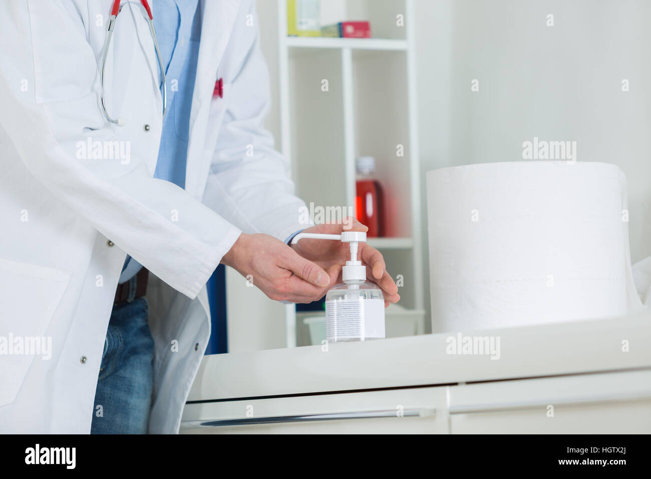 medical doctor using sanitizer dispenser in clinic Stock Photo - Alamy