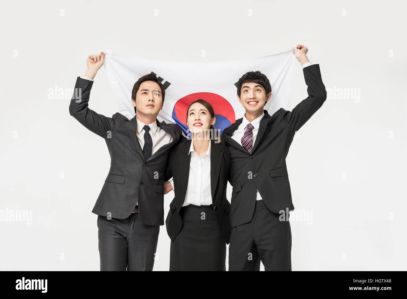 Young smiling Korean business people cheering Stock Photo - Alamy