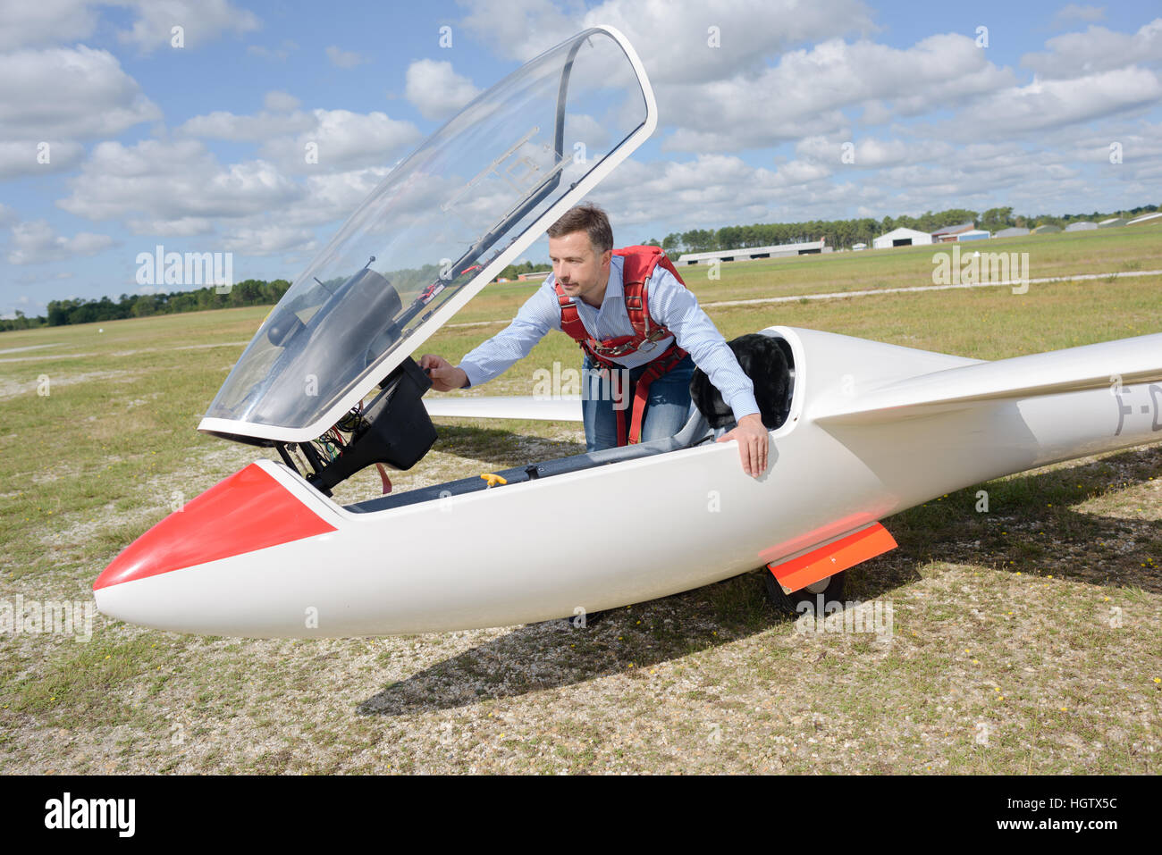 Man getting into glider Stock Photo - Alamy