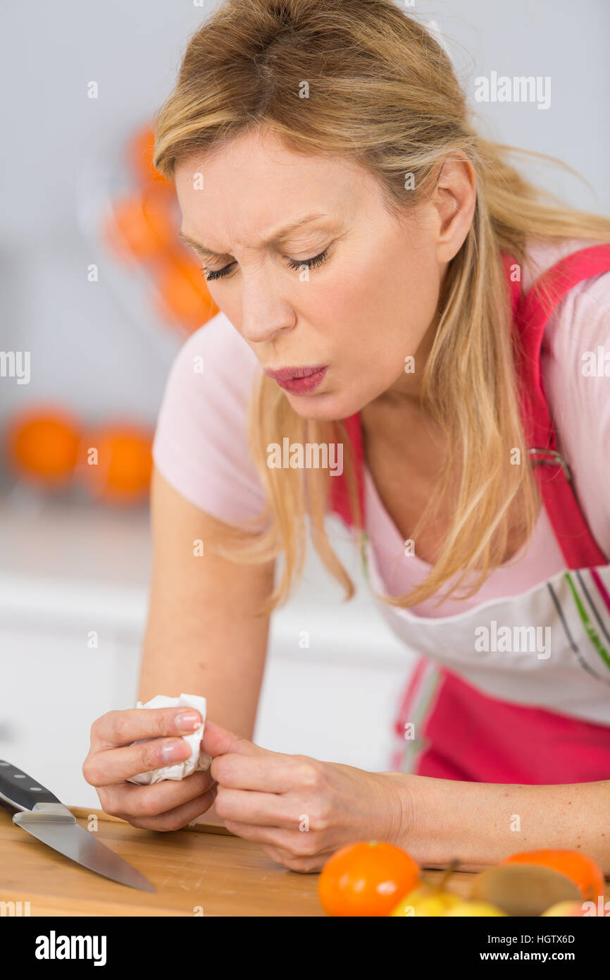 home cook cuts her finger with knife while cooking Stock Photo - Alamy