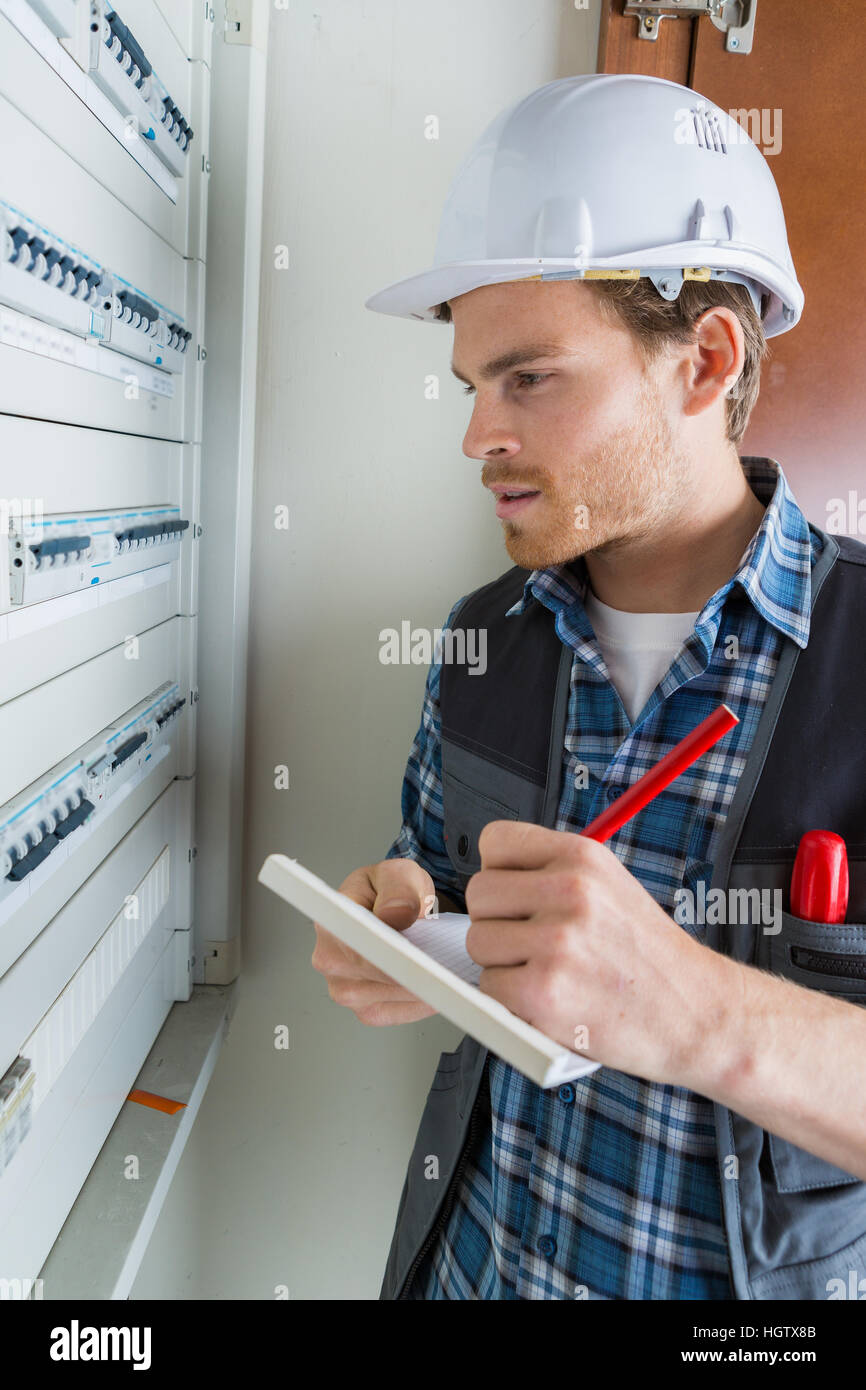 young electrician working on electric panel Stock Photo - Alamy