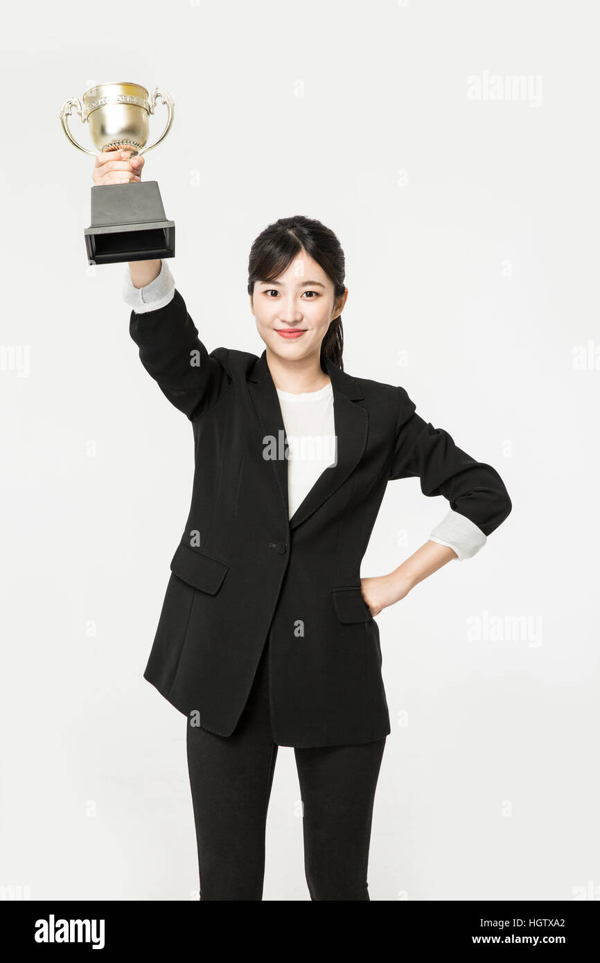 Young smiling business woman cheering with a trophy Stock Photo - Alamy Young smiling business woman cheering with a trophy Stock Photo - Alamy