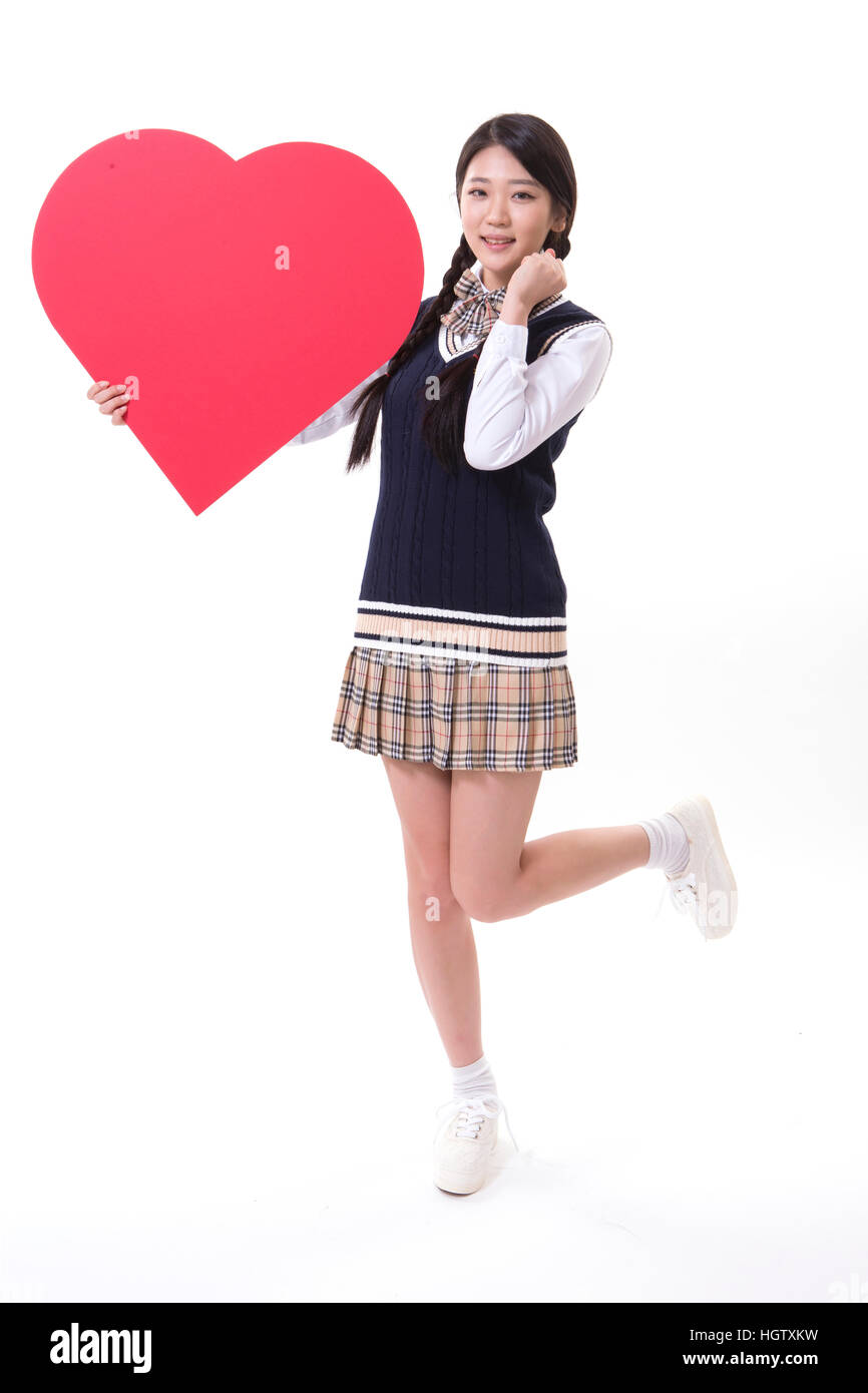 Smiling high school girl posing with heart Stock Photo - Alamy